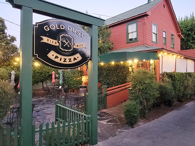Gold Dust Pizza's charming red building and twinkling patio lights create the kind of ambiance that makes even a simple pizza night feel like a special occasion.