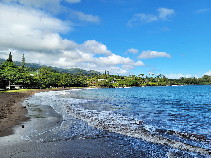 Hāna Bay's gentle waves whisper secrets of old Hawaii, while its black sand beach offers a front-row seat to the most spectacular show on earth&mdash;nature simply being itself.