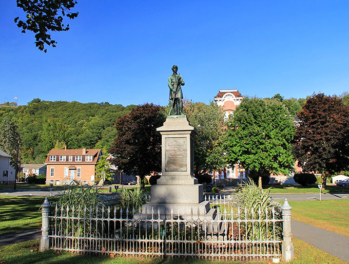 Central Park's statue stands guard over Honesdale like a historical sentinel, surrounded by greenery that offers a peaceful respite from, well, absolutely nothing—the town is already peaceful.