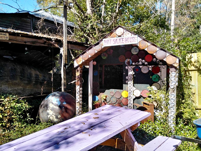 The whimsically named "Hot Sauce House" isn't for condiments but for contemplation—a folk art shelter adorned with colorful bottle caps.