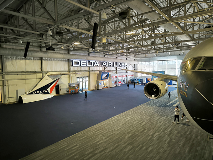 Where else can you stand beneath actual aircraft wings without TSA asking why you're lingering suspiciously near the emergency exits? 