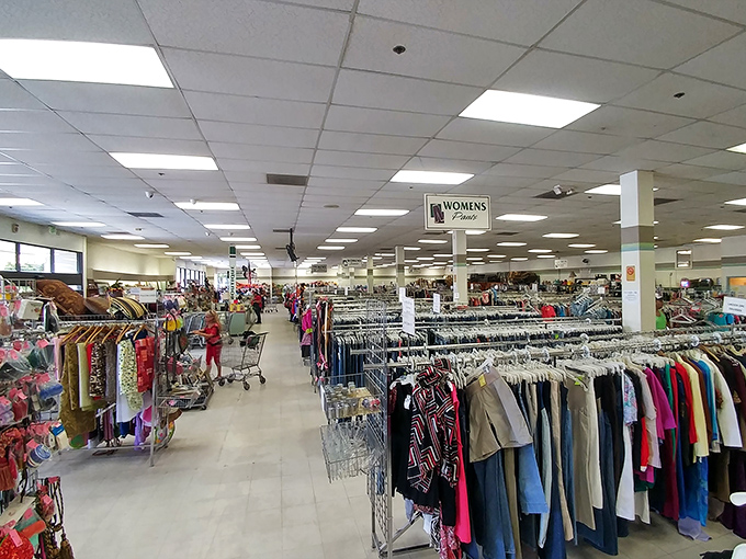 The women's section stretches into infinity, a kaleidoscope of previously-loved fashion waiting for its second act. Marie Kondo's nightmare is a thrifter's dream come true.