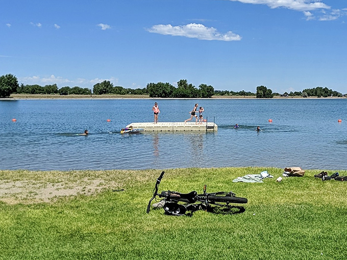 Jensen Grove's summer scene: where bikes rest while kids perfect their cannonball technique off the floating dock.