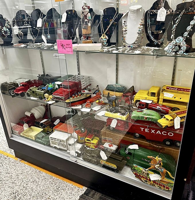 Toy cars and vintage jewelry share space in this display case&mdash;childhood memories and adult treasures coexisting like roommates from different decades.
