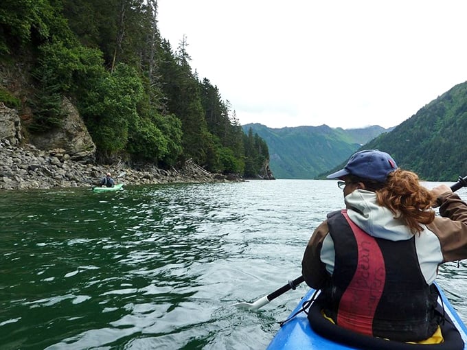 Kayaking through nature's cathedral &ndash; where forest-draped cliffs plunge into emerald waters and office emails cease to exist.
