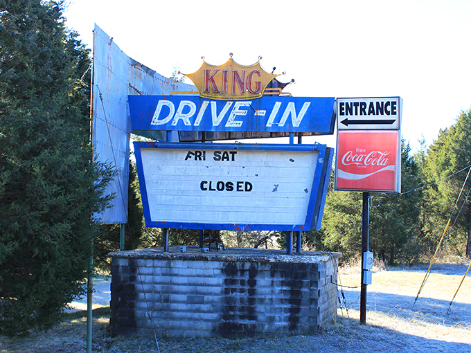 The King Drive-In sign stands as a nostalgic reminder of when date night meant adjusting tinny speakers and hoping the movie was better than your car's heater.