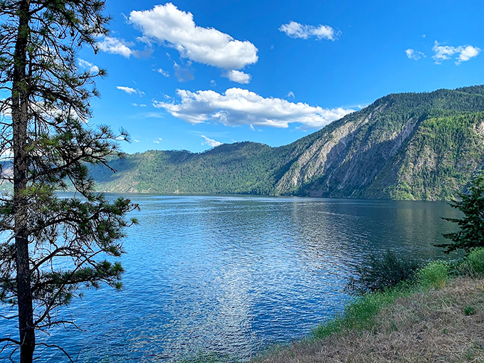 Mountains stand guard over Lake Pend Oreille's crystal waters, a view so spectacular it makes smartphone cameras feel wholly inadequate.