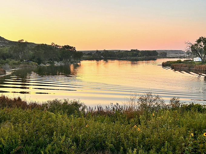 Sunset paints the lake in colors Bob Ross would've called "happy little reflections" &ndash; pure Kansas magic.