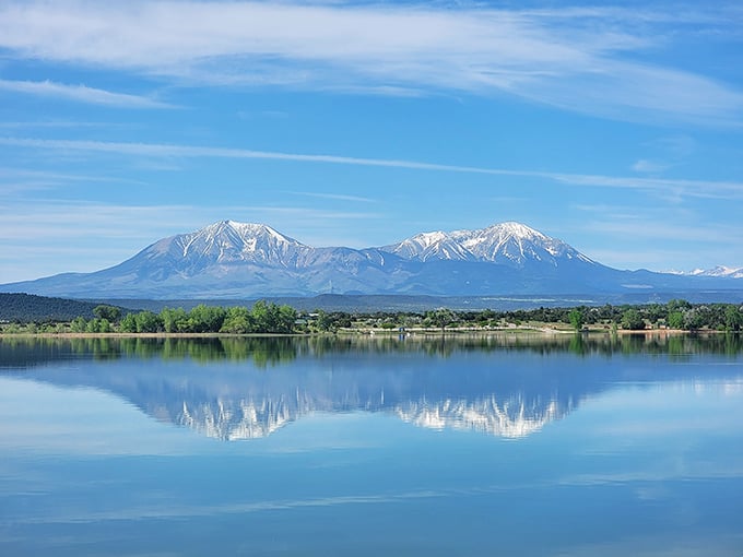 The Spanish Peaks reflect perfectly in Lathrop State Park's waters, proving nature doesn't charge admission for spectacular views.