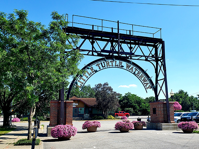 The Little Turtle Waterway entrance, adorned with vibrant flowers, welcomes visitors to one of Logansport's most charming natural attractions.