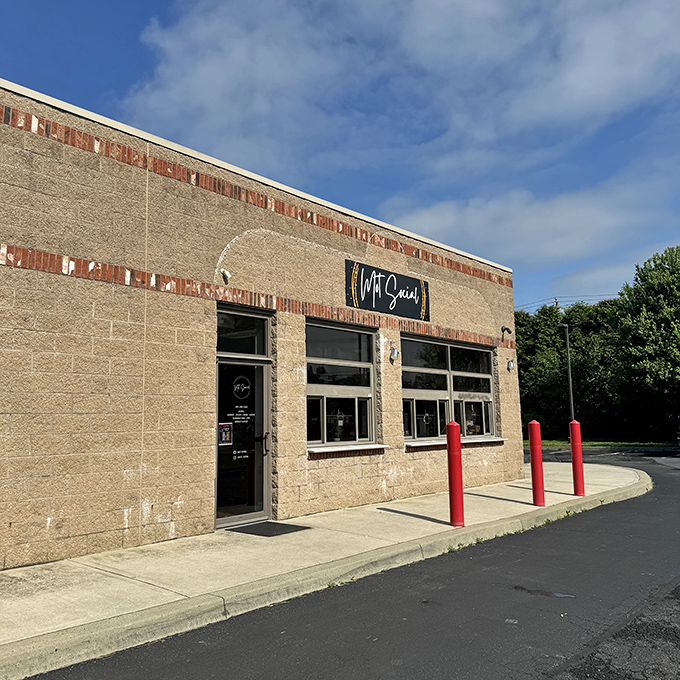 MOT Social's unassuming exterior hides a gathering spot where locals swap stories and newcomers become regulars. Those red bollards aren't just decorative&mdash;they're protecting precious caffeine territory.