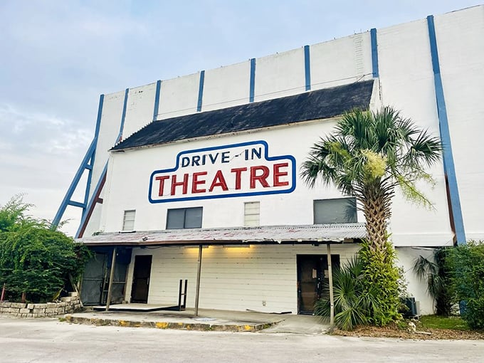 The iconic white facade of the Ocala Drive-In stands like a cinematic monument, complete with that classic red and blue signage that screams "simpler times."