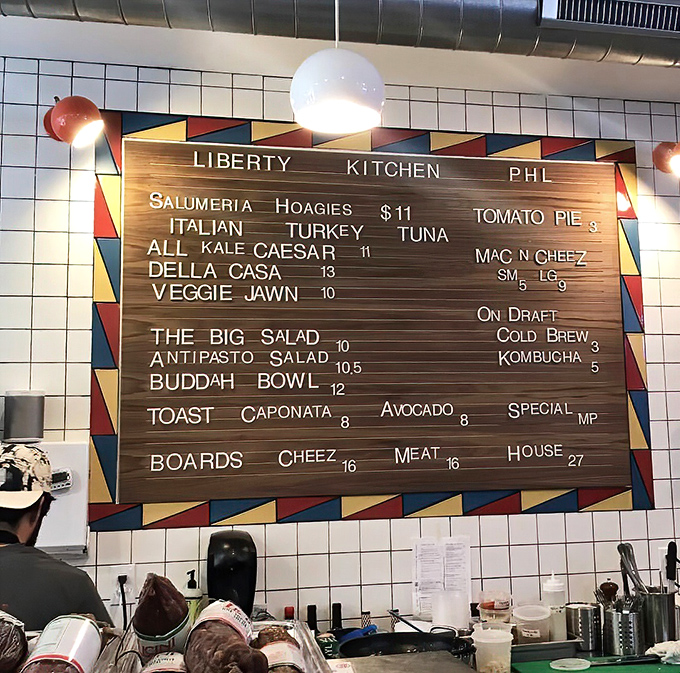 The menu board &ndash; a wooden masterpiece showcasing Liberty Kitchen's focused selection of hoagies, salads, and local favorites.