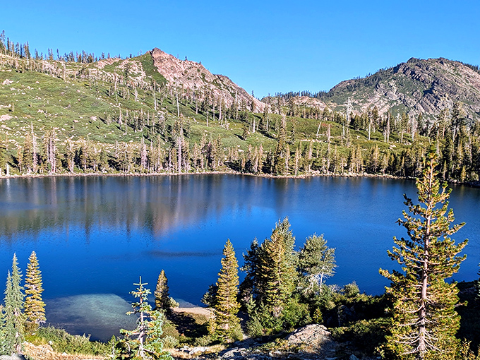 Nature's infinity pool! This crystal-clear mountain lake mirrors the rugged peaks, offering tranquility you can't find in any day spa.