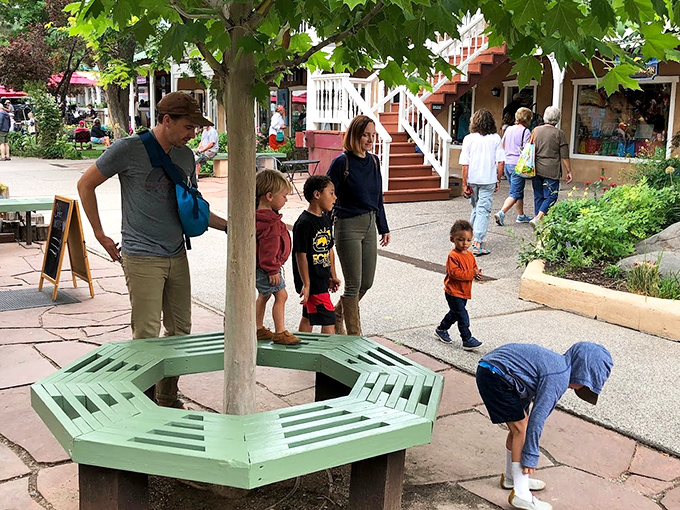 Family moments unfold beneath leafy canopies in Taos' pedestrian-friendly center. That green bench? Nature's perfect waiting room for ice cream decisions.