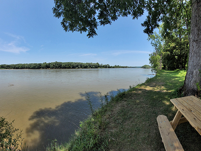 A picnic table with million-dollar river views where sandwiches somehow taste better and conversations flow like the water beyond.