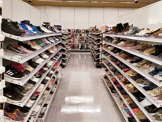 The shoe aisle at America's Thrift Stores stretches into infinity, a runway of possibilities where Cinderella stories happen daily without the midnight deadline.