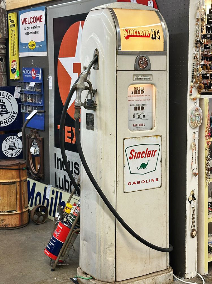 That vintage Sinclair pump stands as a silent sentinel to an era when gas was measured in gallons, not mortgage payments.