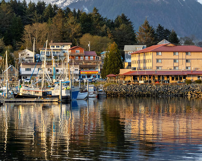 Golden hour transforms Sitka's harbor into a painter's dream—fishing vessels resting after a day's work while waterfront buildings glow in the sunset.