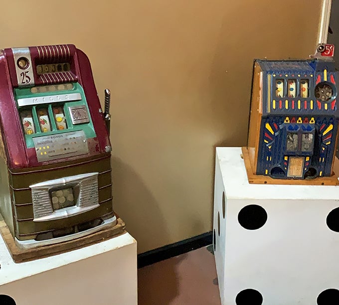 Vintage slot machines stand ready, their mechanical guts exposed&mdash;silent witnesses to countless dreams and empty pockets.