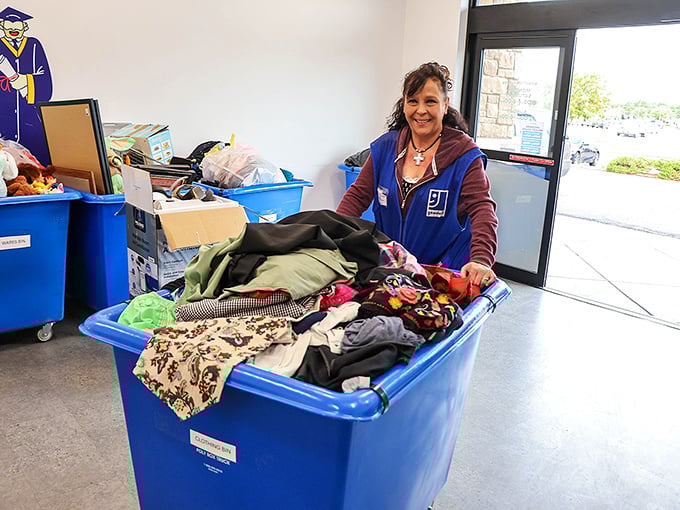 Behind every great thrift store is a dedicated team sorting treasures. That smile says, "I just found something good in this bin!"
