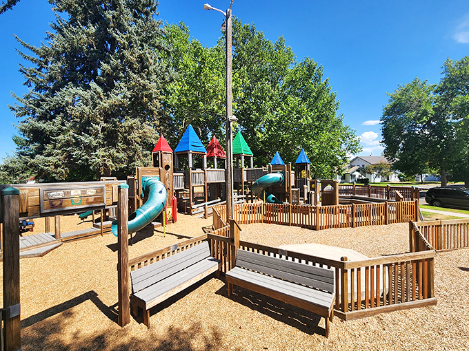 Storybook Park delivers childhood joy with colorful towers and slides that make grandparents wish they could still fit down that twisty blue tube.