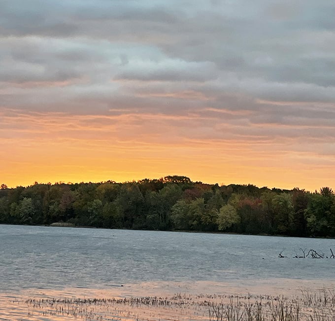 Mother Nature showing off her sunset palette across the lake. Even the clouds seem to pause in appreciation of this golden hour masterpiece.