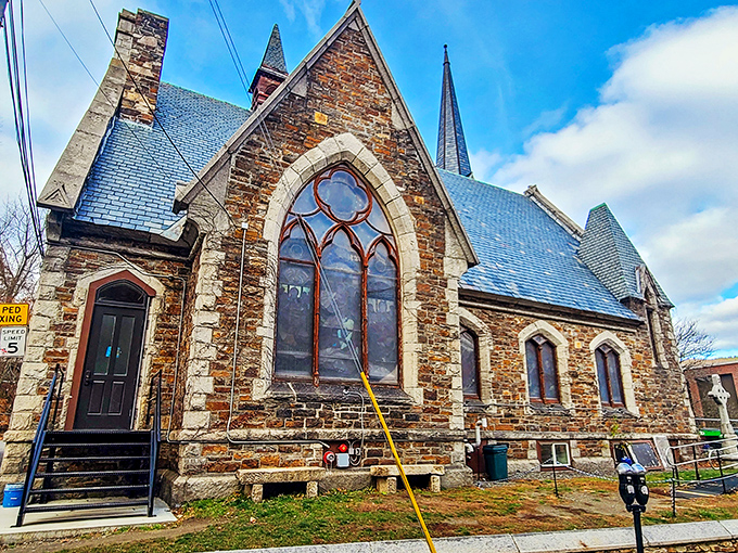 This stone church stands as a testament to craftsmanship from another era, its stained glass windows filtering Vermont sunlight into colored poetry.