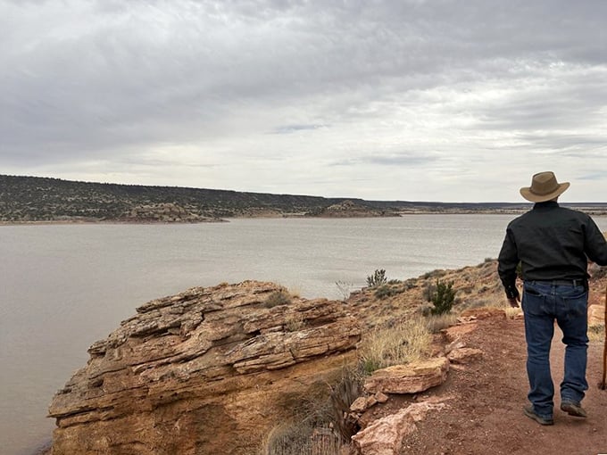 Where desert meets water&mdash;a hiker pauses to soak in the vastness of northeastern Arizona's hidden aquatic gem.