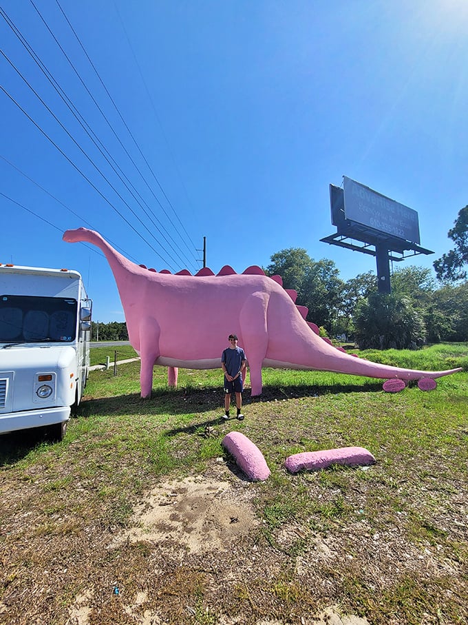 Scale becomes apparent when humans stand beside this prehistoric pink giant&mdash;a roadside photo op that's impossible to resist.