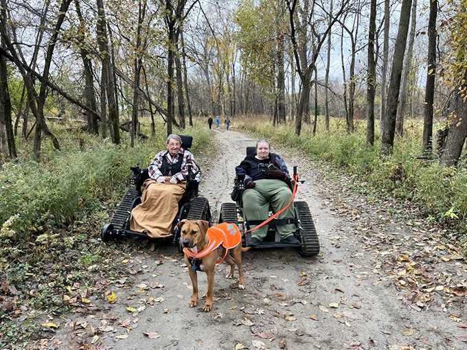 All-terrain track chairs prove that Mother Nature should be accessible to everyone. That happy dog seems to have appointed himself tour guide extraordinaire. 