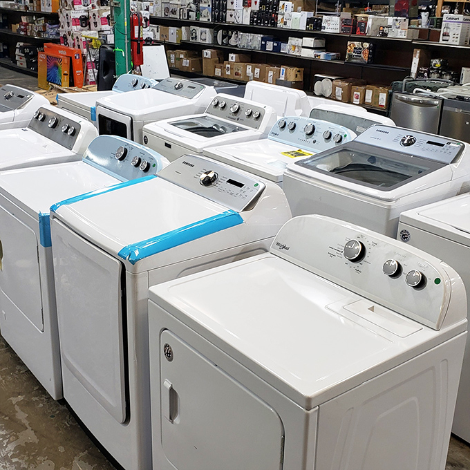 Washing machines standing at attention like appliance soldiers, each with minor imperfections and major savings.