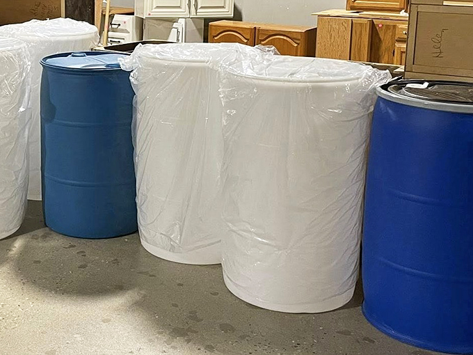 These aren't just water drums – they're rain collection systems waiting to happen or emergency preparedness in disguise.