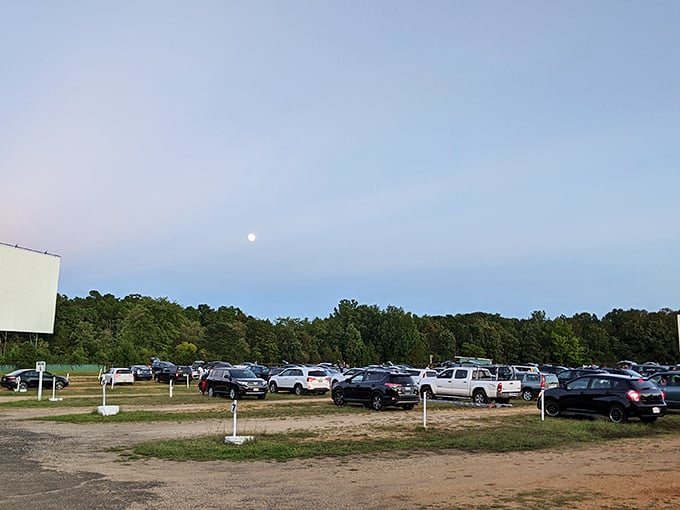 As twilight falls and the moon rises, vehicles settle into their spots. Cinema under the stars isn't just entertainment&mdash;it's pure magic.