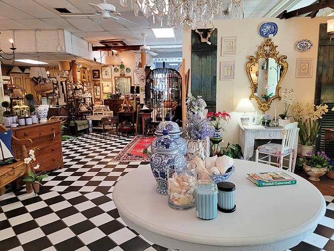 The classic checkerboard floor sets the perfect stage for this elegant vignette where blue and white porcelain meets gilded mirrors in perfect harmony.