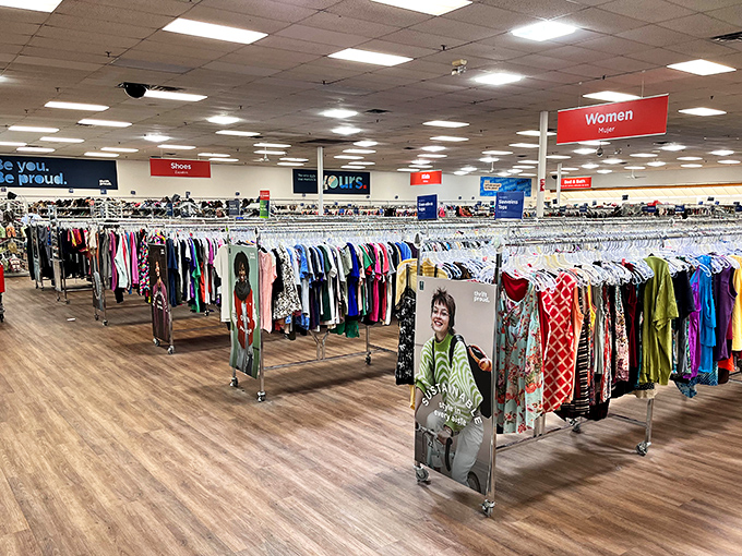 Endless racks stretch toward the horizon like a textile ocean. The color-coded organization system is the only thing keeping chaos at bay.