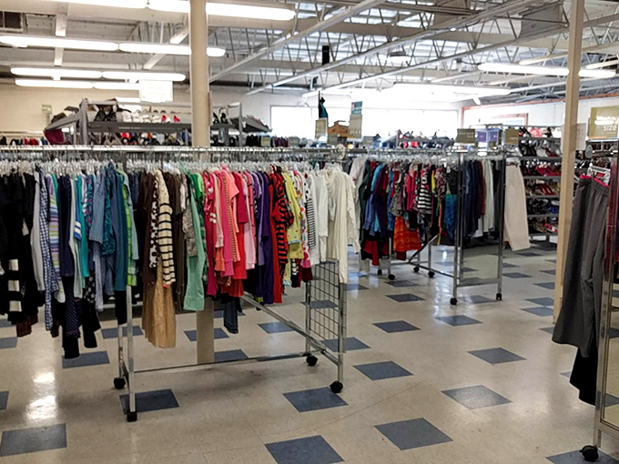 A thrifter's paradise where clothing racks create a maze of potential. Each aisle promises the thrill of finding that perfect something you didn't know you needed.