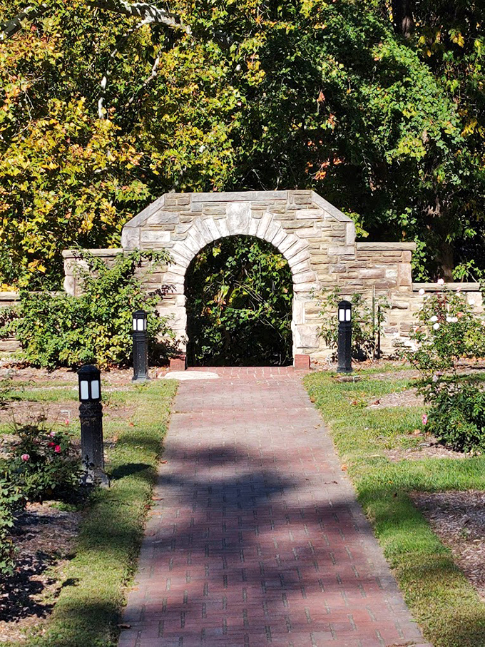 Not all who wander are lost, but all who enter this stone archway find something magical. The garden's elegant entrance promises wonders beyond.