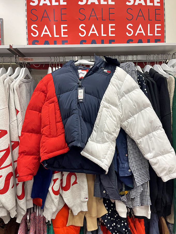The universal language of SALE speaks volumes at outlet stores, where these patriotic puffer jackets await savvy shoppers with an eye for seasonal steals.