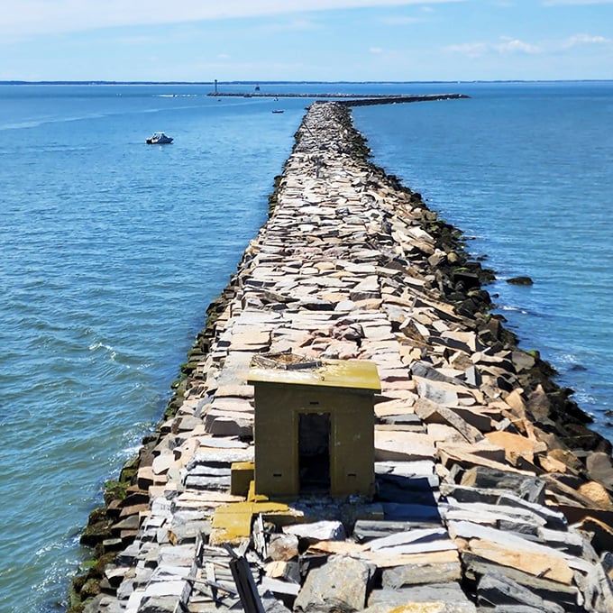 That moment when you realize the lighthouse isn't floating on water but standing at the end of an impressive stone breakwater&mdash;maritime engineering that's stood the test of time.