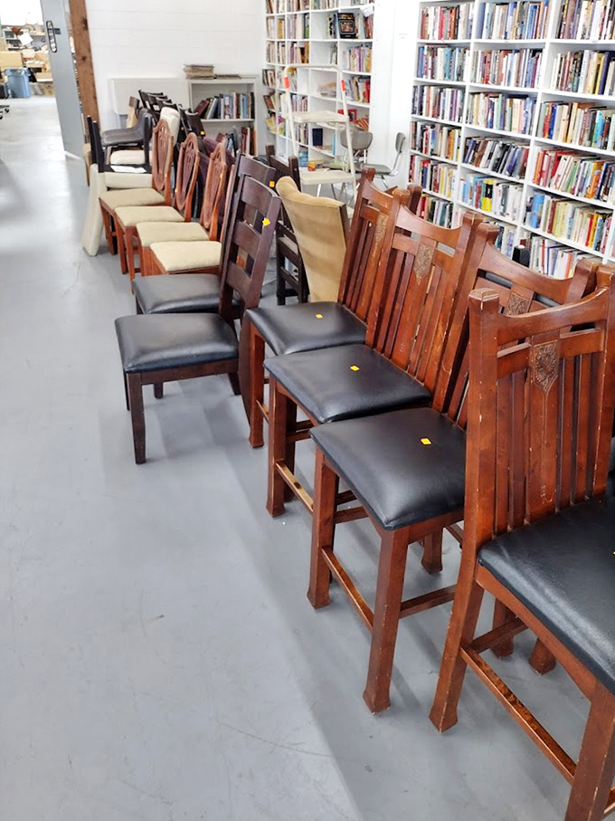 Dining chairs stand at attention beside towering bookshelves&mdash;a bibliophile's dream where literature meets comfortable seating arrangements.