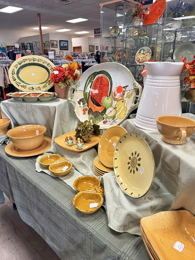 Amber-hued dishware and decorative plates with fruit motifs await new homes. One person's castoffs become another's dinner party conversation starters.