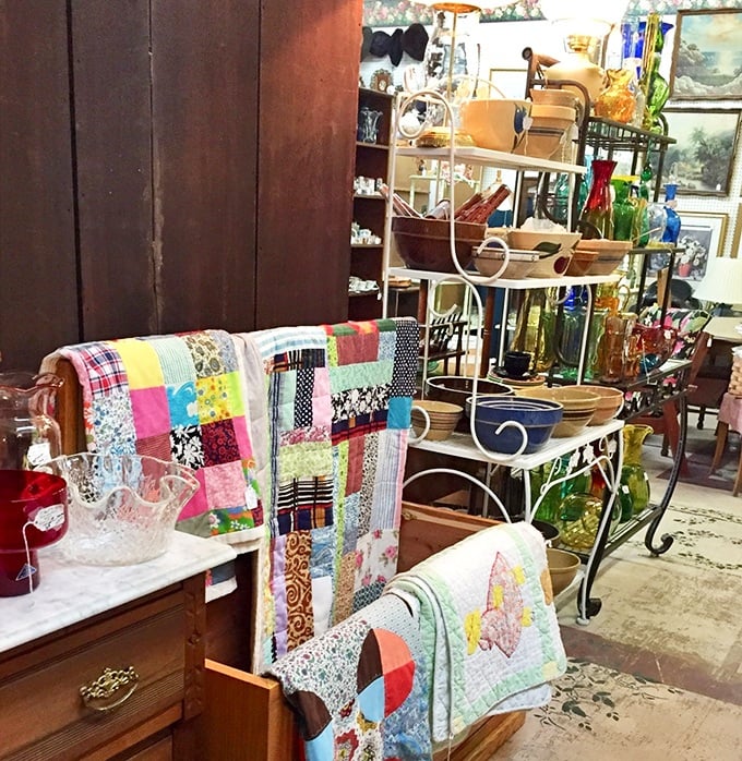 Handmade quilts draped over furniture create a rainbow of textile artistry, each stitch telling stories of patience our smartphone era has forgotten. 