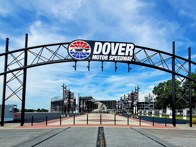 Dover International Speedway's entrance arch frames Miles perfectly, like a portal to a world where concrete creatures rule the racetrack.
