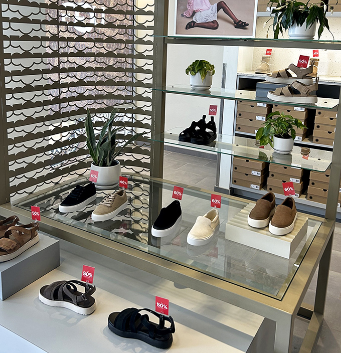 Shoe paradise where 50% off tags bloom like spring flowers. Even the potted plants seem to be celebrating the savings.