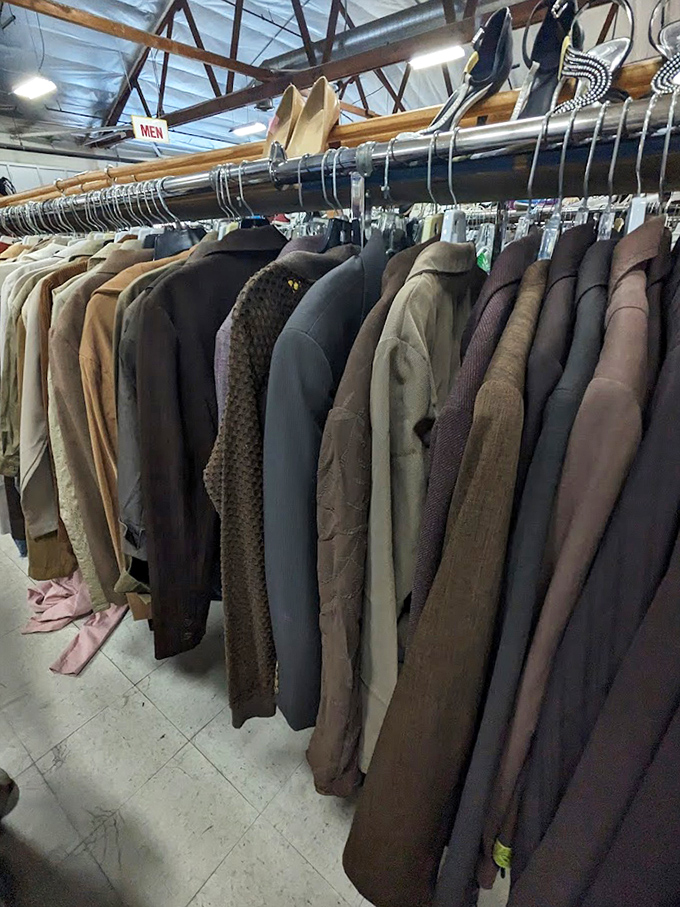 The men's coat section could outfit a film noir detective agency—quality overcoats and blazers hanging patiently for their second act.