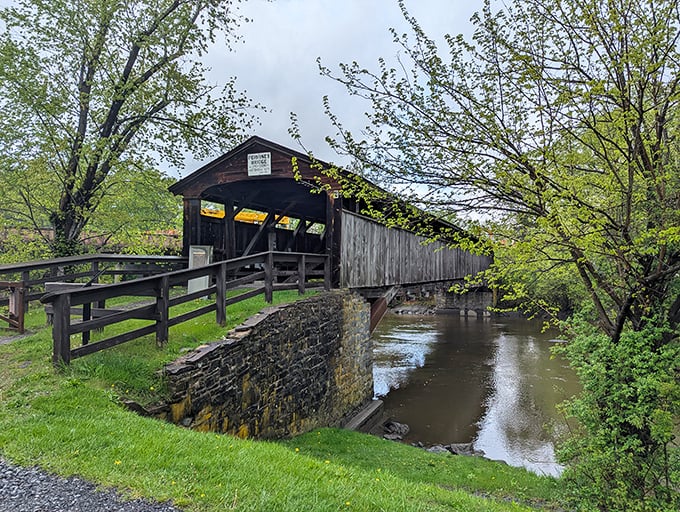 The bridge's entrance beckons visitors into its wooden embrace, a portal to simpler times.