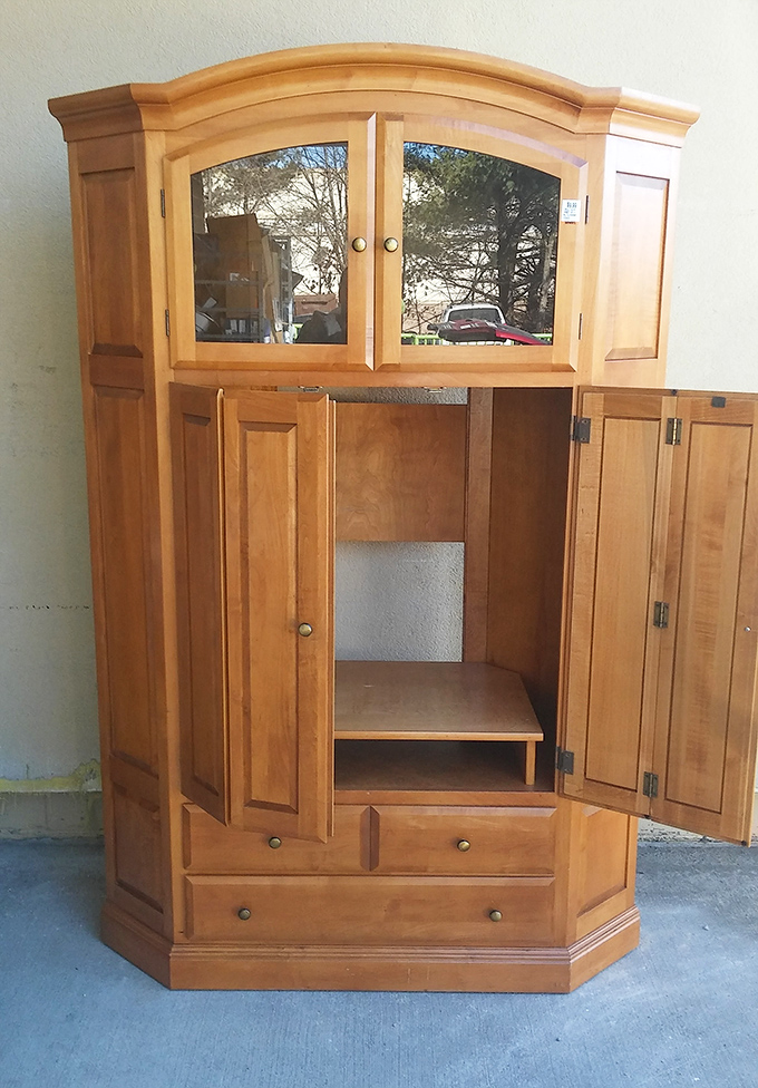 This solid wood entertainment center waits patiently for its second act—like Sean Connery making a comeback in "The Hunt for Red October."