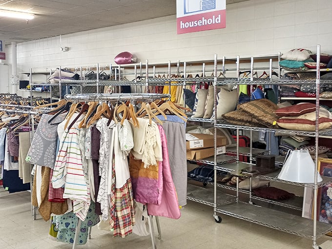 Under the "household" sign, a textile rainbow awaits&mdash;linens, curtains, and cushions ready for their second act in your home.