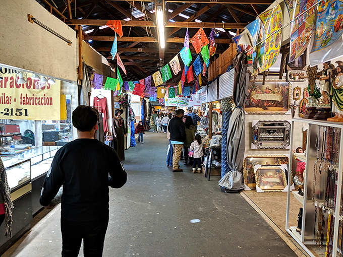 Interior pathways lined with colorful banners and diverse merchandise create the perfect labyrinth for Saturday morning explorers seeking unexpected treasures.
